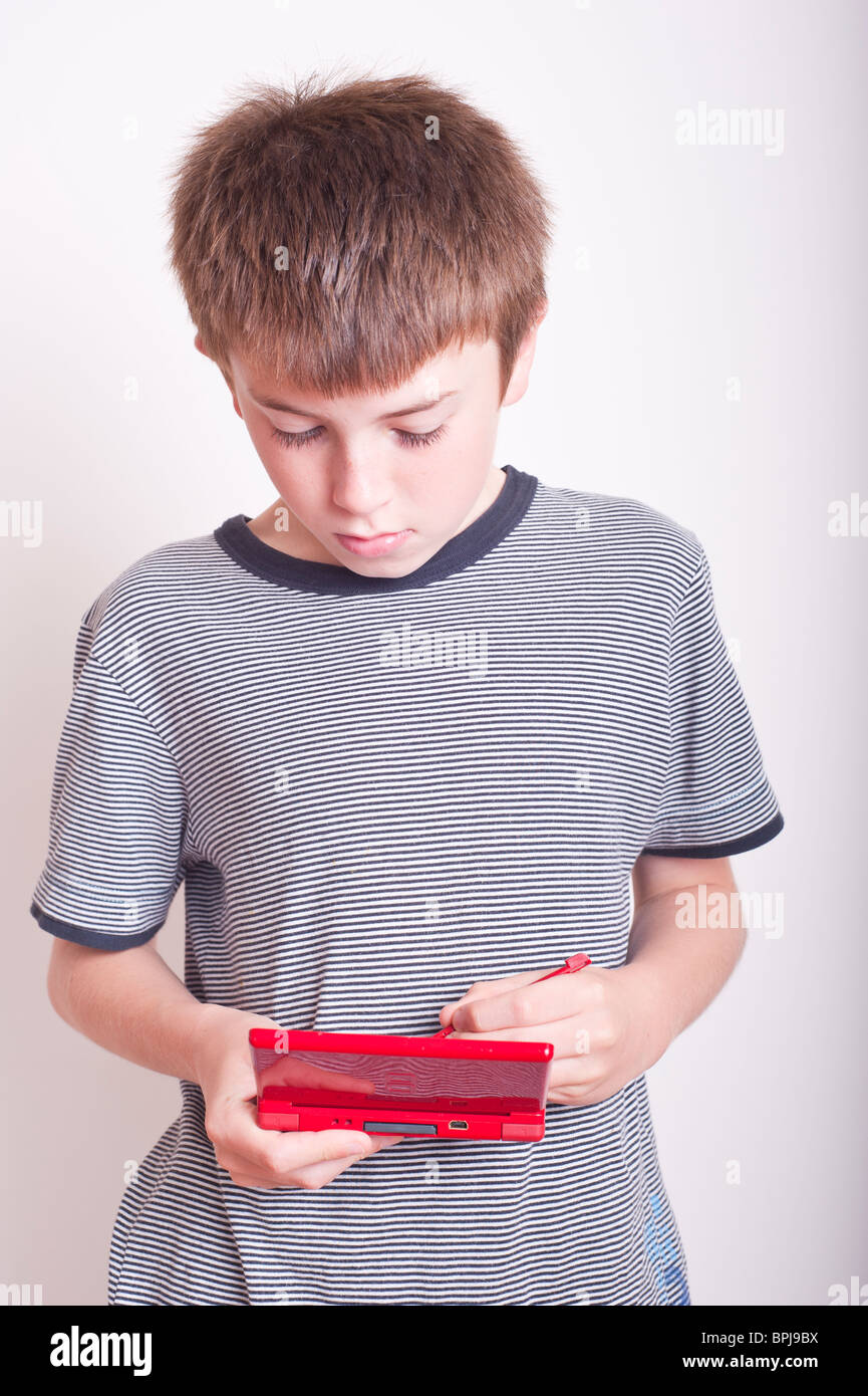 A MODEL RELEASED picture of a 10 year old boy playing with a Nintendo ...