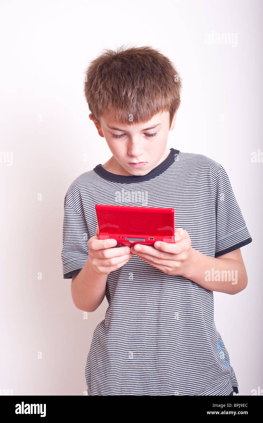 A MODEL RELEASED picture of a 10 year old boy playing with a Nintendo ...