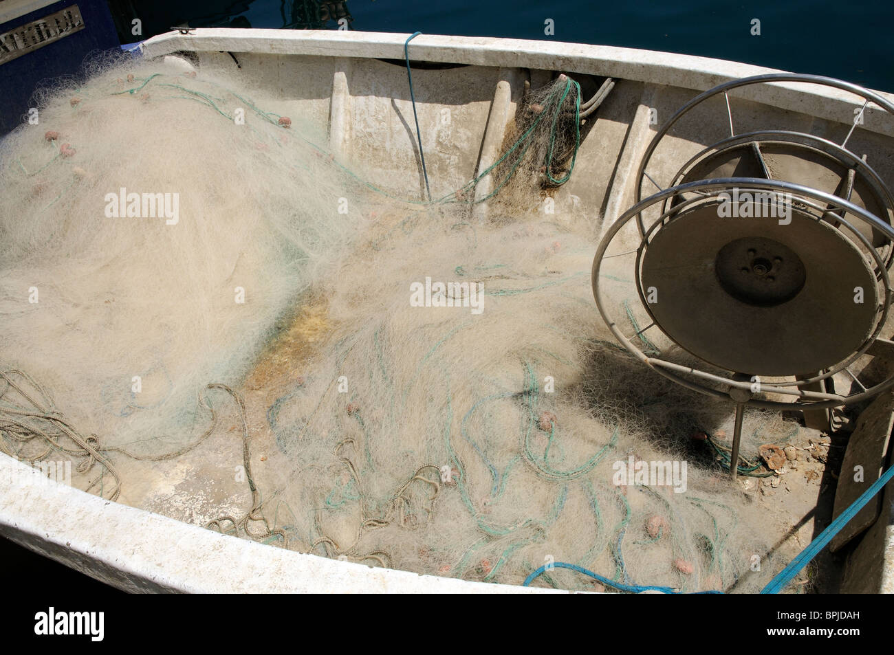 Fishing net laying in a fisherman's boat Stock Photo - Alamy
