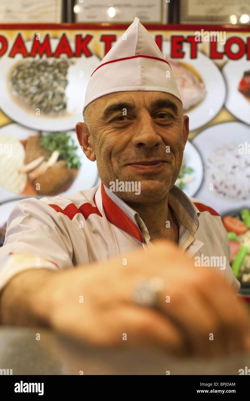 cook with hat behind the counter of a small restaurant, Istanbul ...