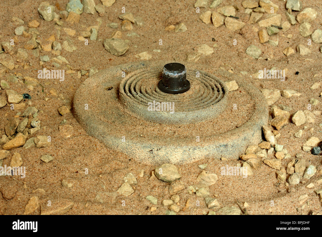 An IED mine exposed in the desert sand Stock Photo - Alamy