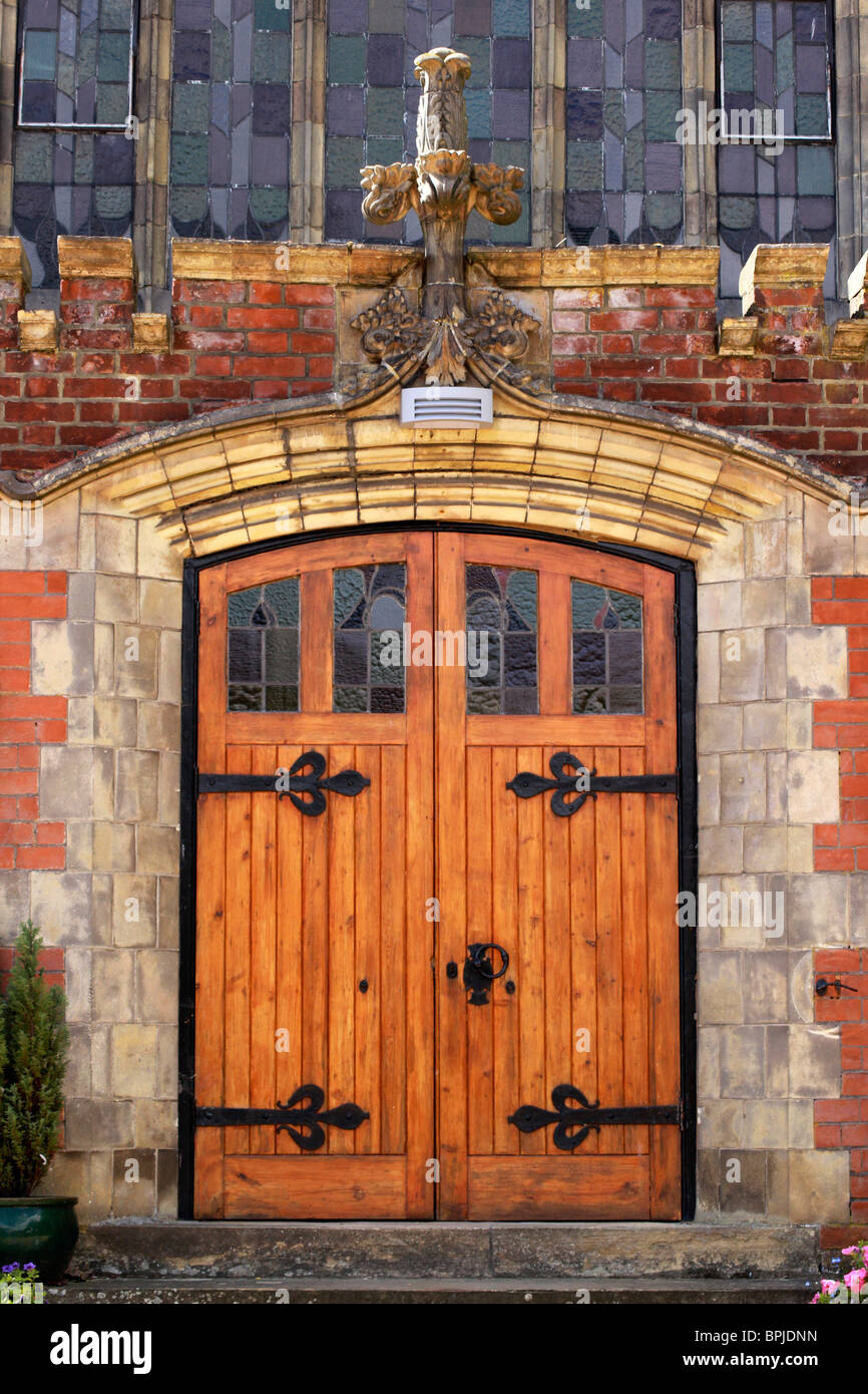 Double wooden doors to a village chapel Stock Photo - Alamy