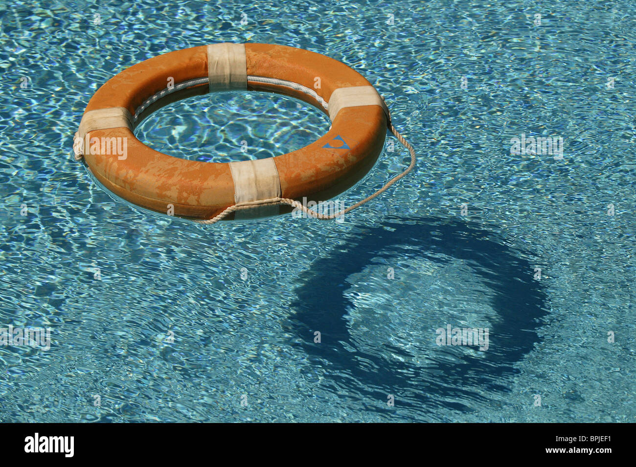 Life ring floating in a swimming pool, Safety Stock Photo - Alamy