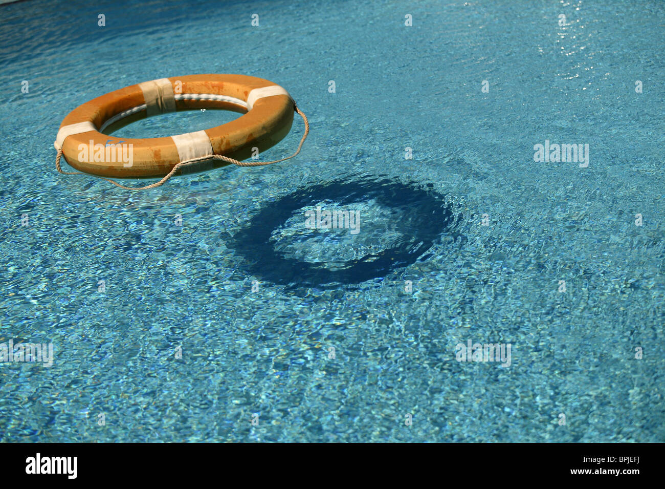 Life ring floating in a swimming pool, Safety Stock Photo - Alamy