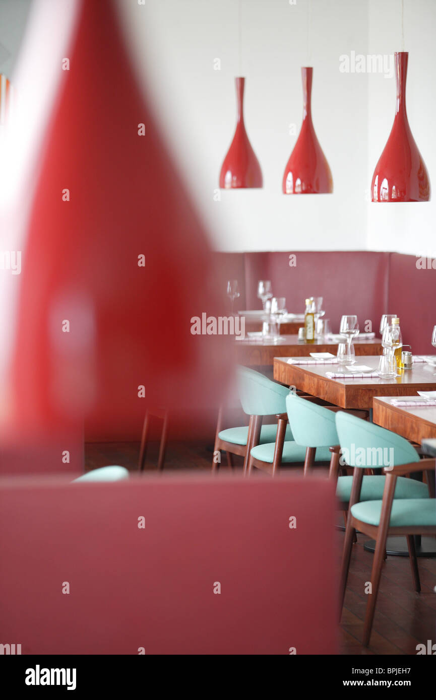 Modern restaurant with red lamps and turquoise chairs Stock Photo - Alamy