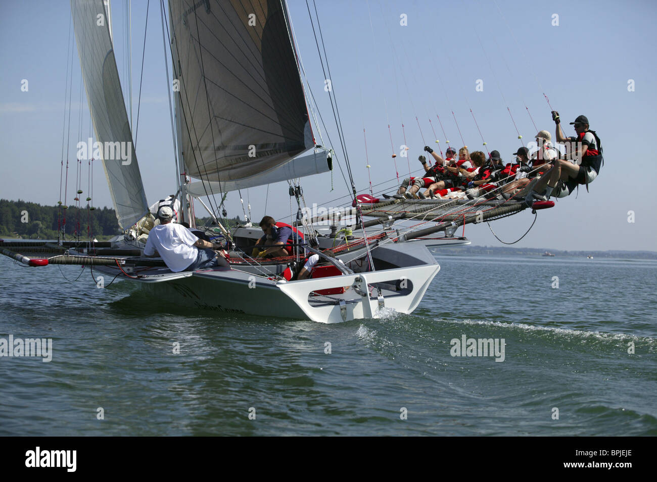 Libera sailing yacht, 8 sailors in the trapeze, Chiemsee, Bavaria ...