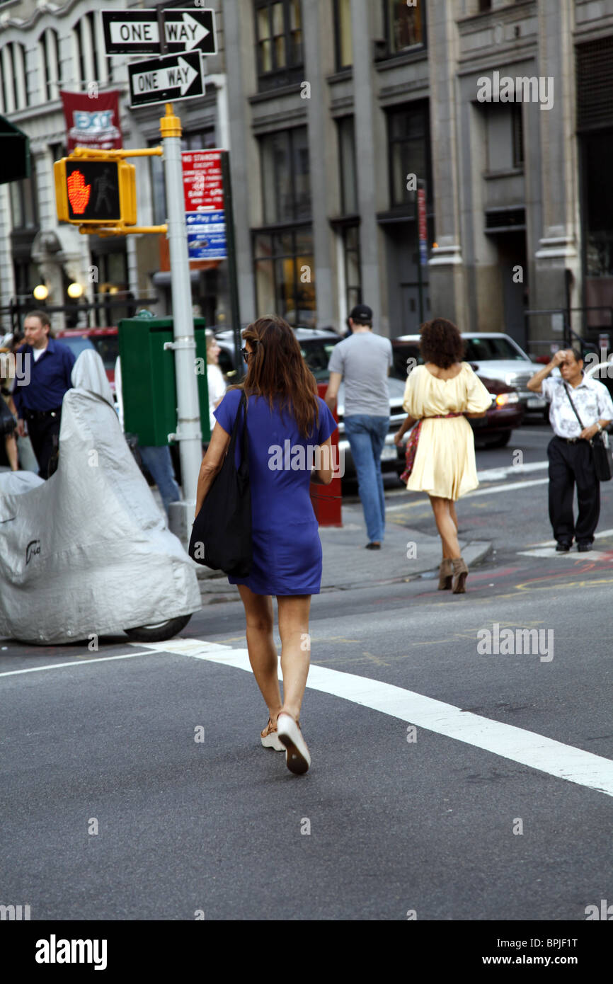 A woman crossing a street in Manhattan, New York. America Stock Photo ...