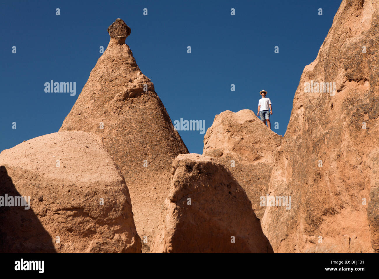 Tourist standing on top of camel valley rocks Stock Photo - Alamy