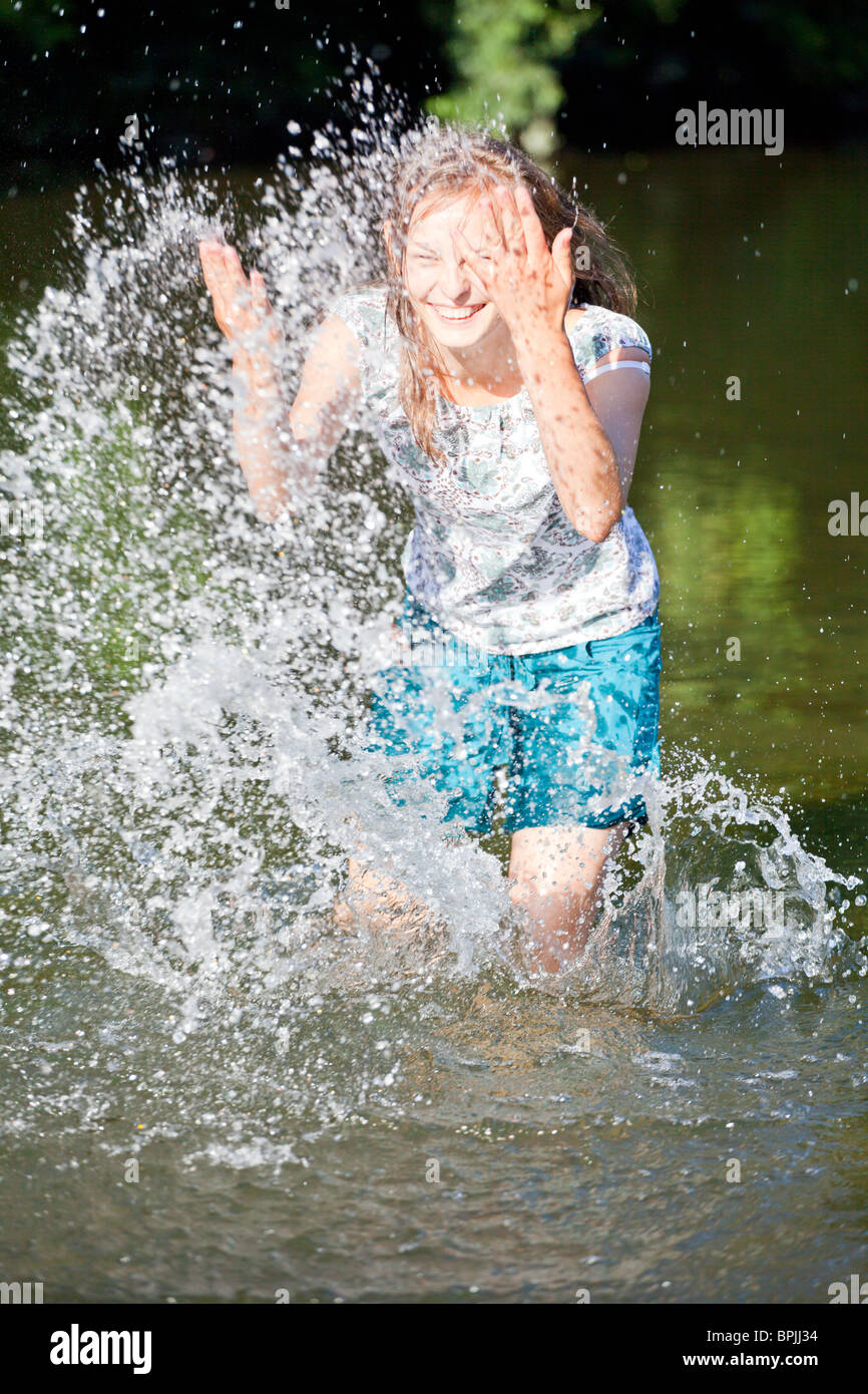 Young woman having fun in a river in summer Stock Photo - Alamy