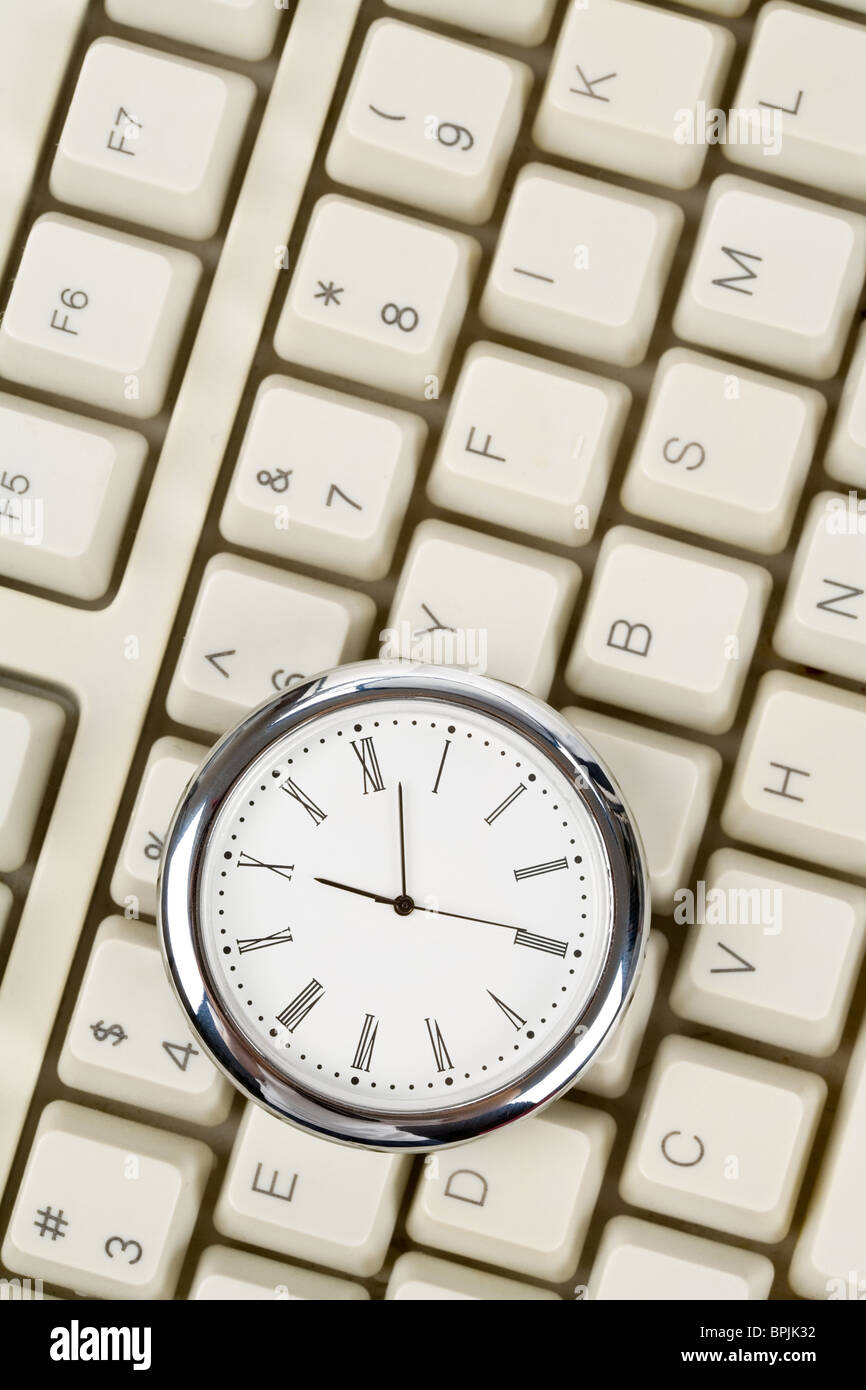Clock and computer Keyboard close up Stock Photo - Alamy