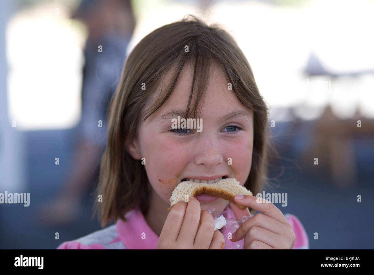 Girl Eating Bread Stock Photo - Alamy