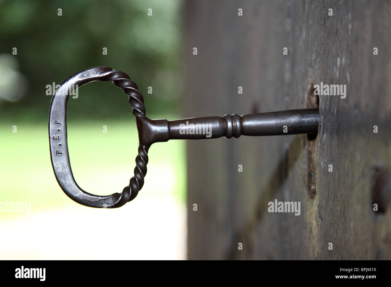 Giant key in the lock of an old wooden church door Stock Photo - Alamy