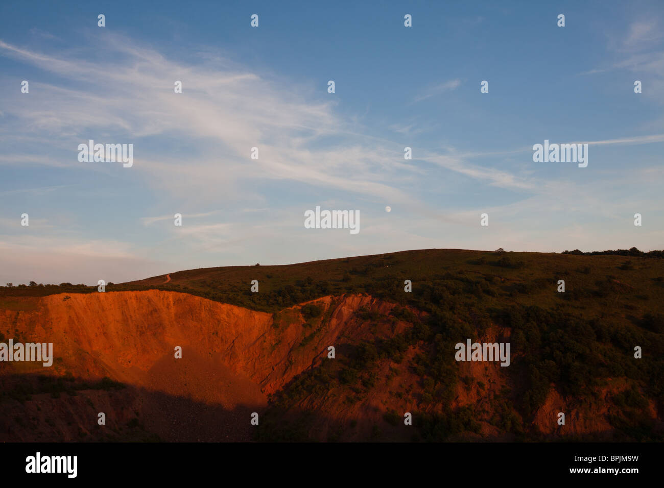 Triscombe Quarry on the Quantocks, Somerset at sunset. The Moon can be ...