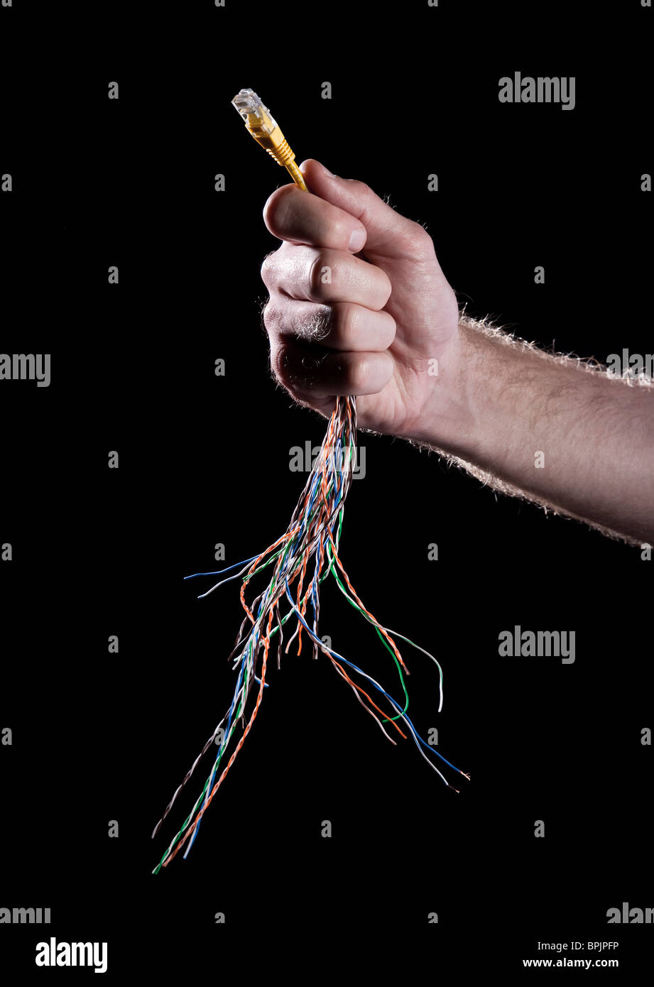 1 Hand holding a torn computer cable with colorful frayed wires coming ...