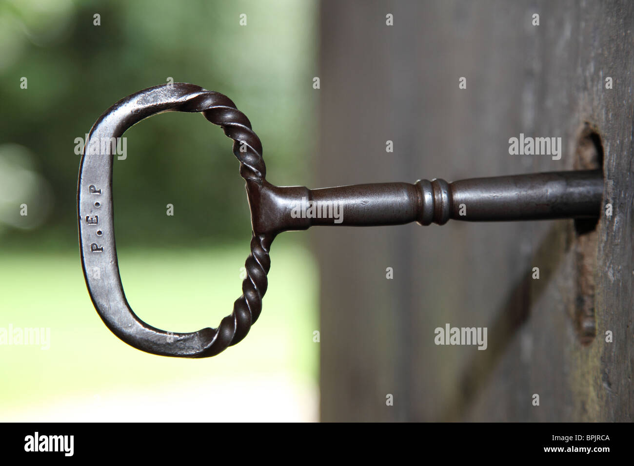 Giant key in the lock of an old wooden church door Stock Photo - Alamy