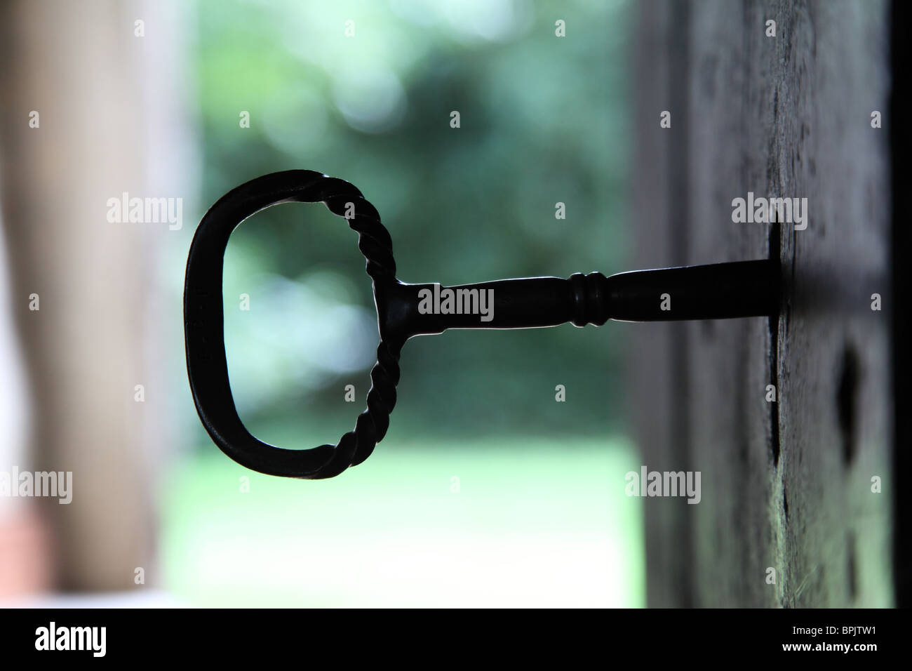 Giant key in the lock of an old wooden church door Stock Photo - Alamy
