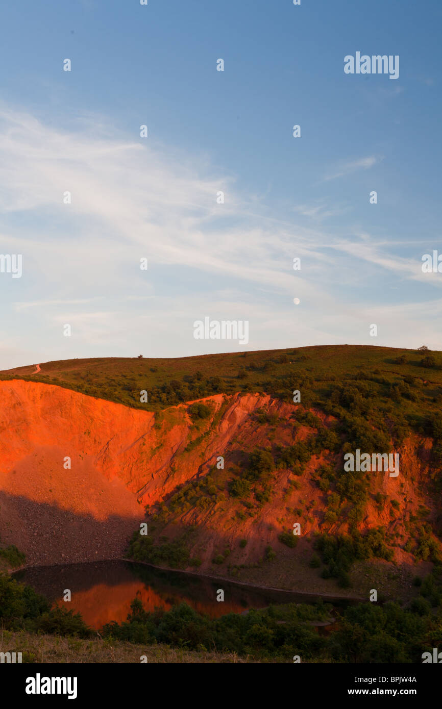 Triscombe Quarry on the Quantocks, Somerset at sunset. The Moon can be ...