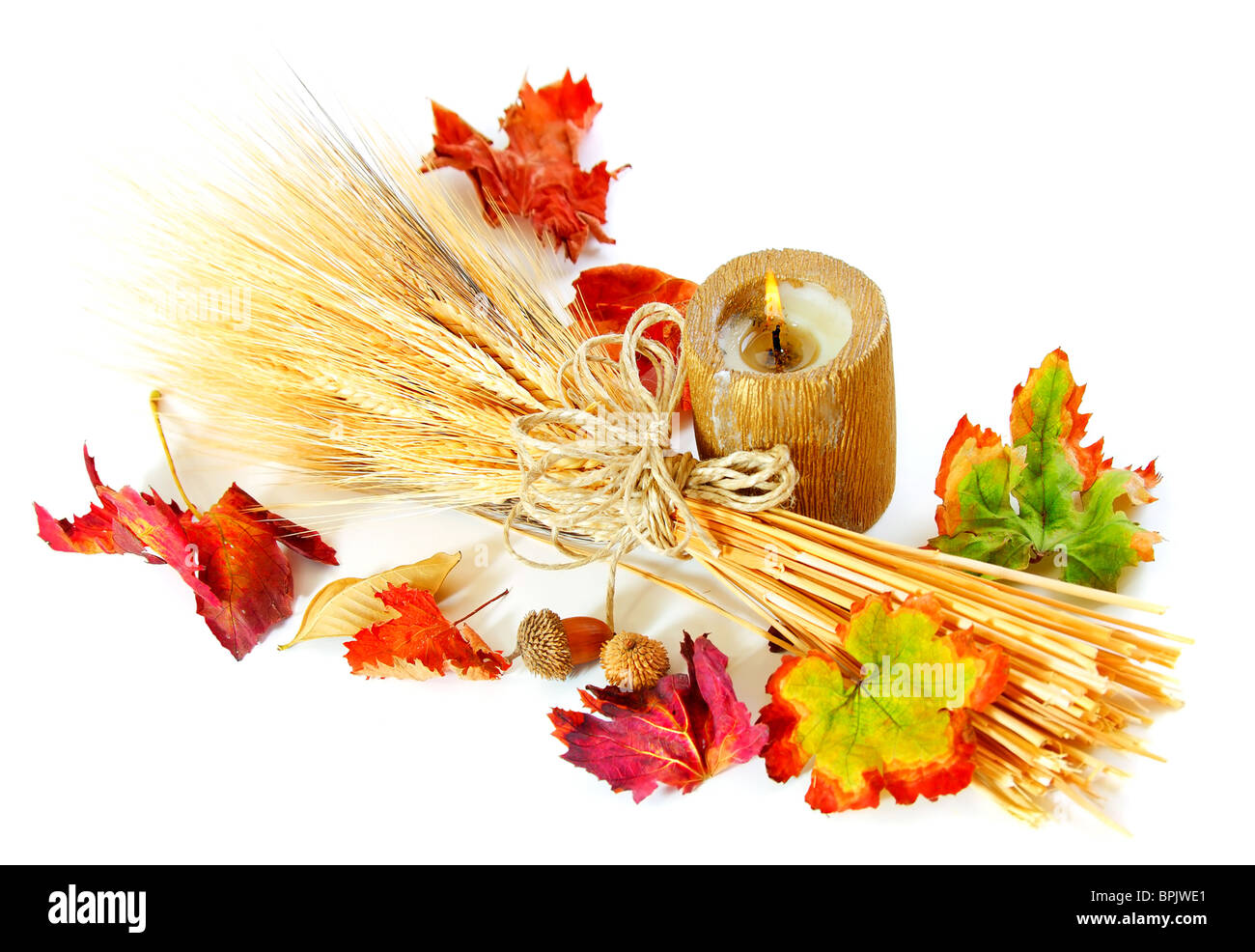 Wheat over white with candle & dry autumn leaves Stock Photo - Alamy