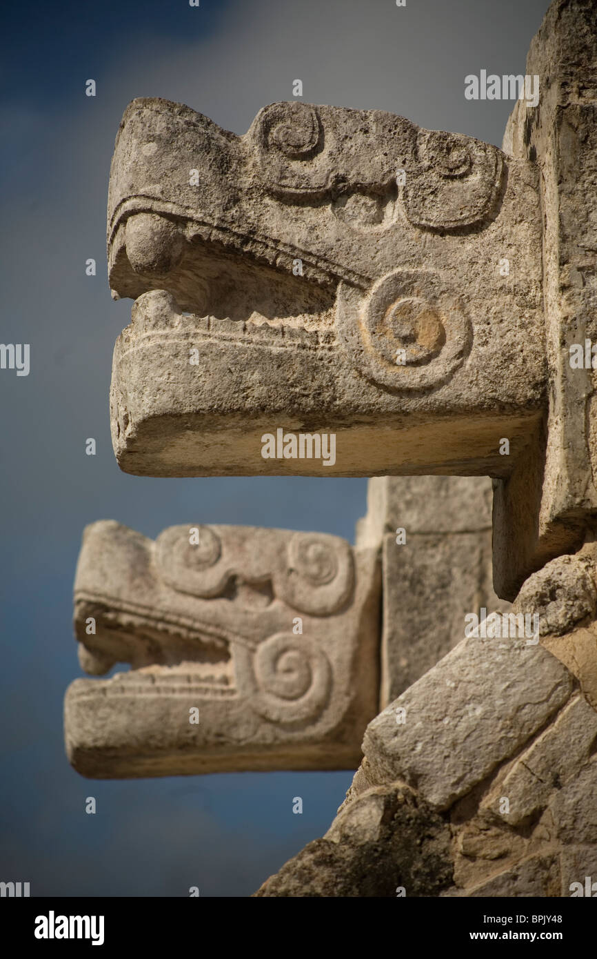 Stone sculptures of snake heads representing Mayan god Kukulkan at the ...
