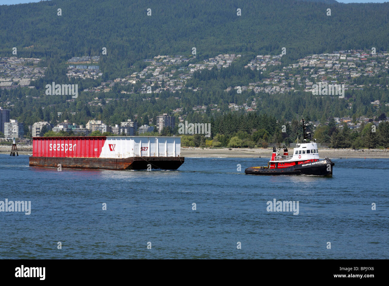 A tugboat pulls a barge through the Lion's Gate in Vancouver, British Columbia Stock Photo - Alamy