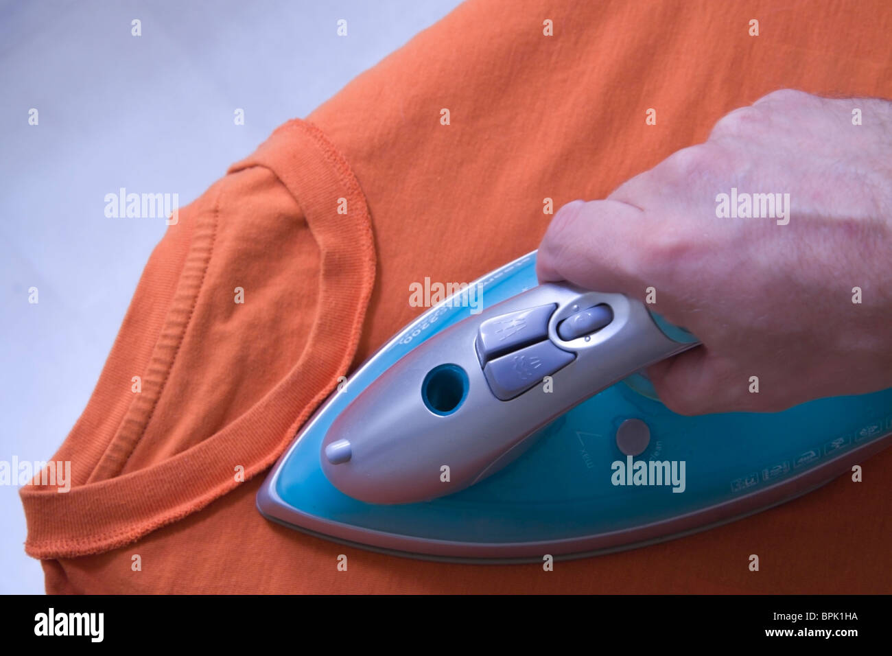 Close up of a man doing the ironing Stock Photo - Alamy