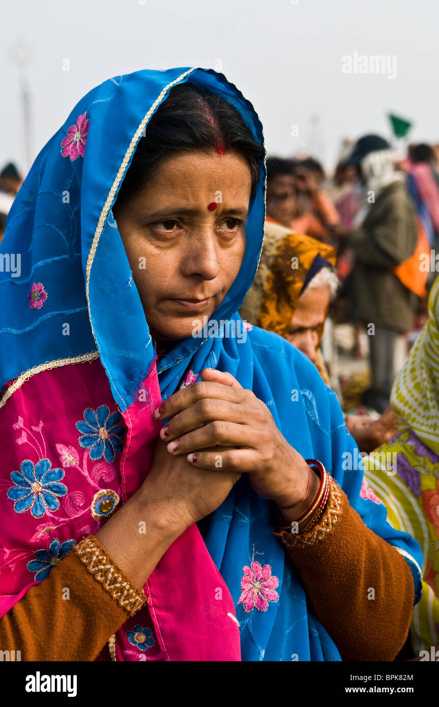 An Indian woman praying at a holy Hindu site Stock Photo - Alamy
