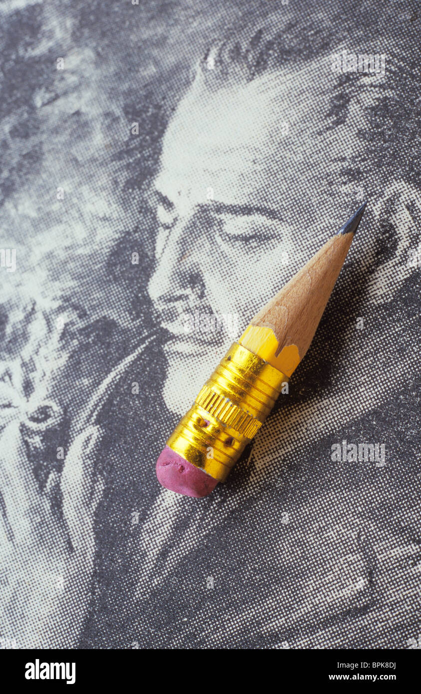 Sharpened pencil stub with eraser attached lying on newsprint drawing ...