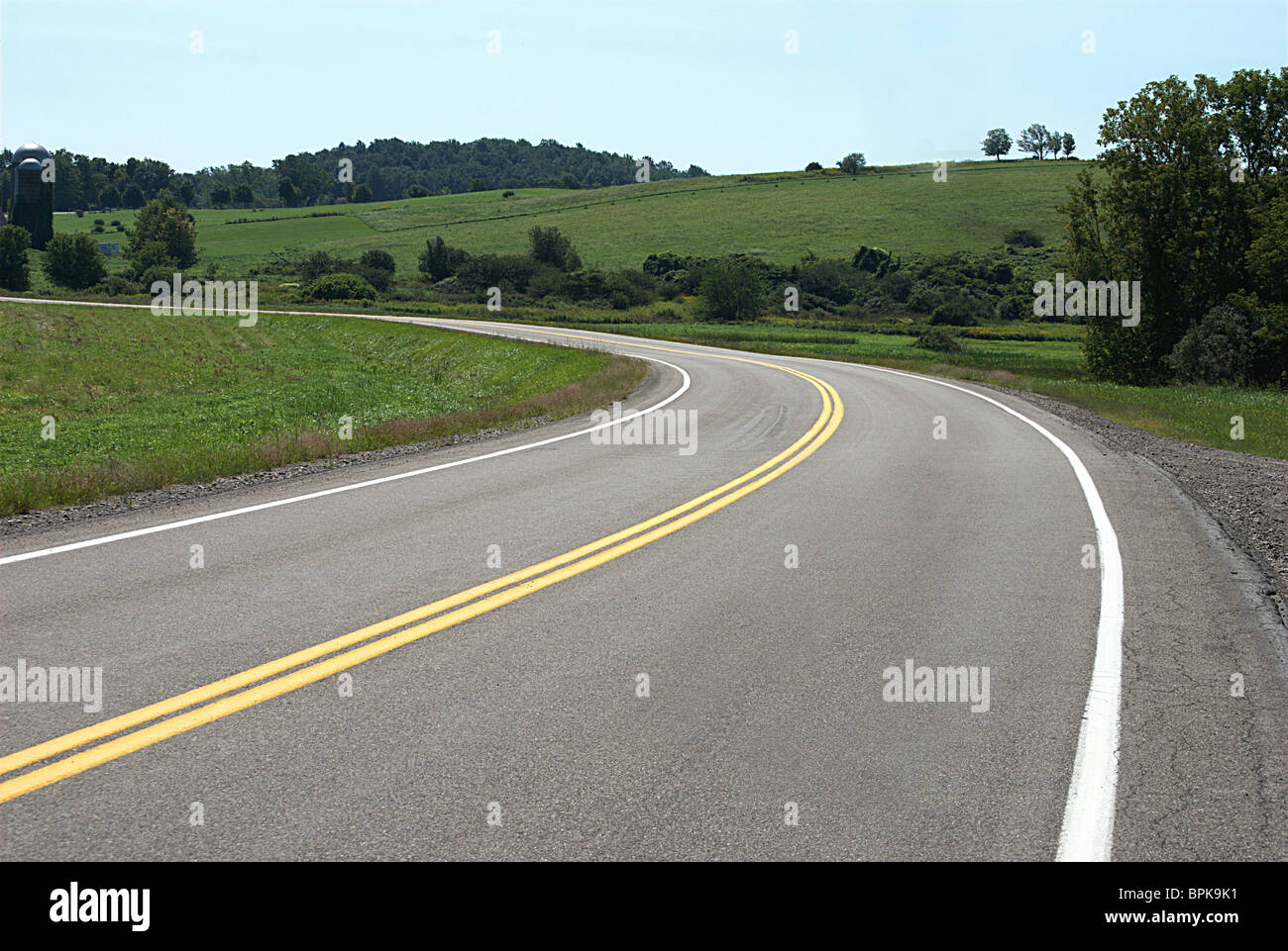 Rural road in up state New York curves to left Stock Photo - Alamy