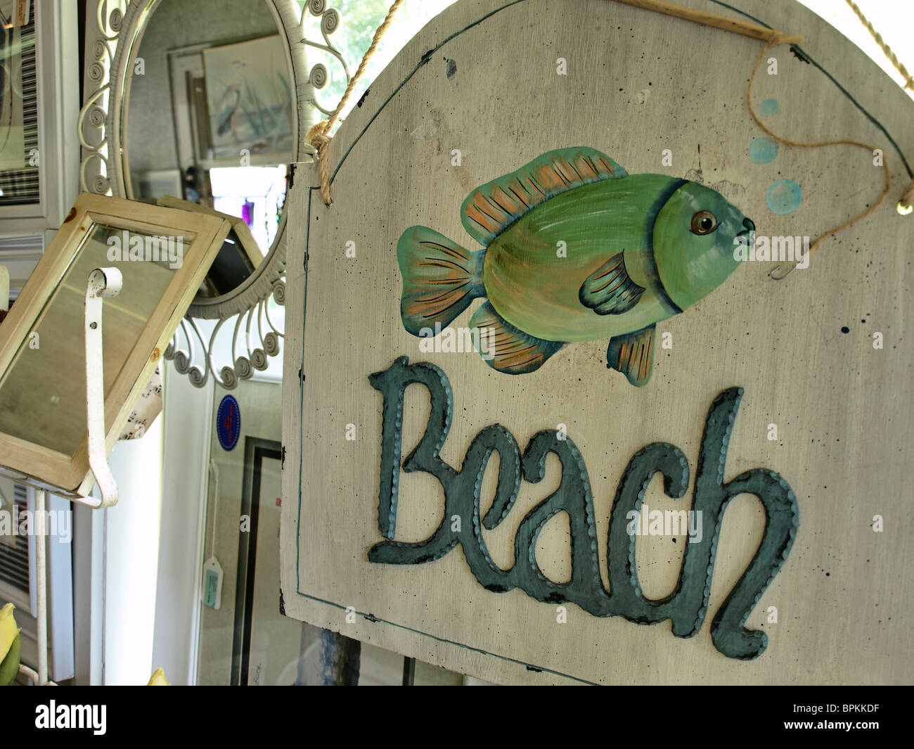 painted sing with green fish and the word Beach on white background in ...