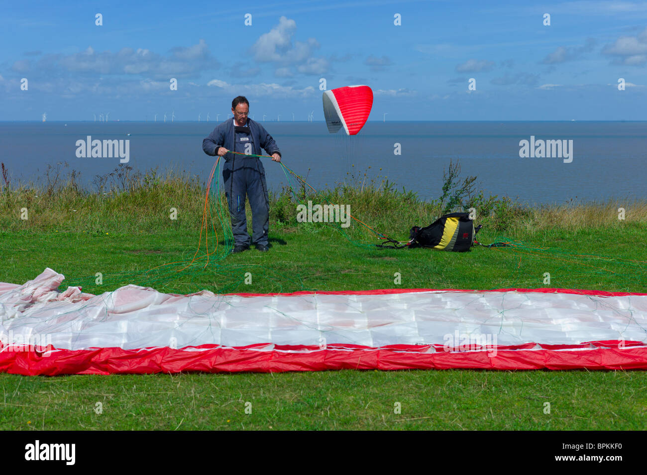 Man folding away Hang Glider Stock Photo - Alamy