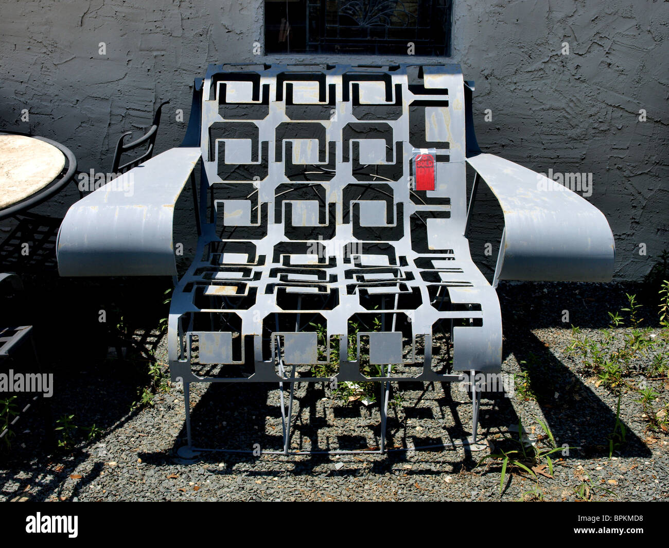 large metal modern chair with big handles and design cut into set and ...