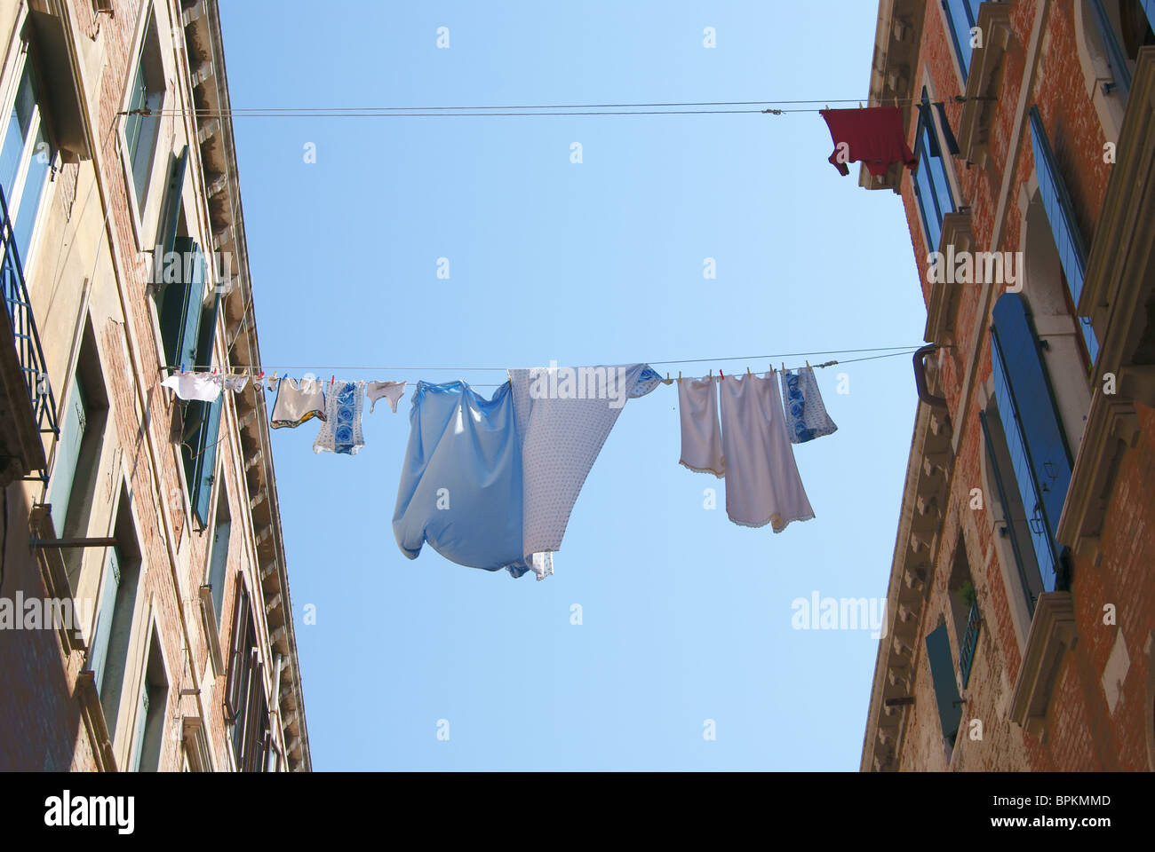 clothesline between houses Stock Photo - Alamy