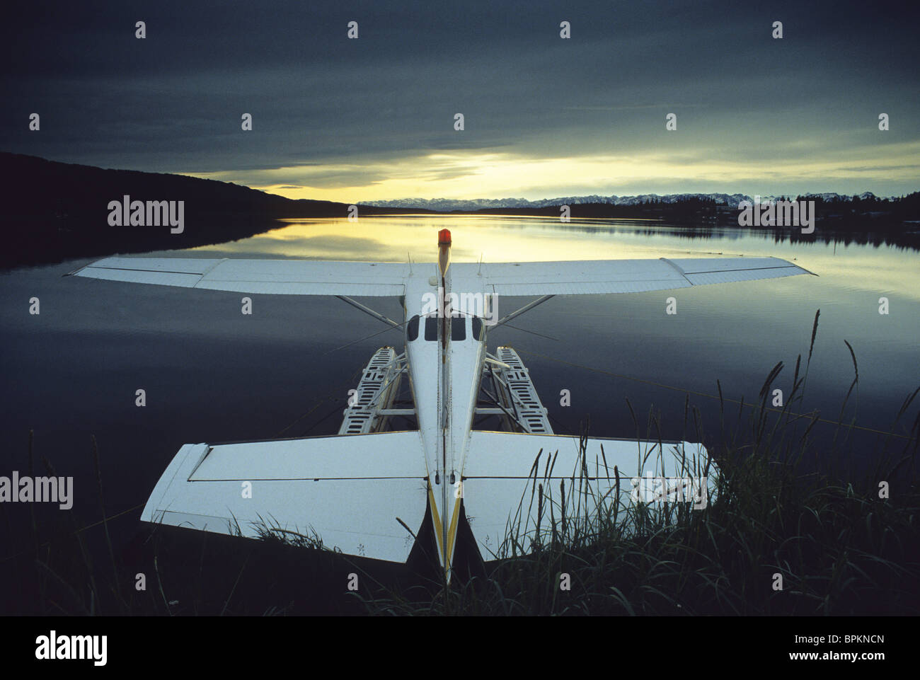 Floatplane at Beluga Lake under dark clouds, Kenai peninsula, Alaska ...