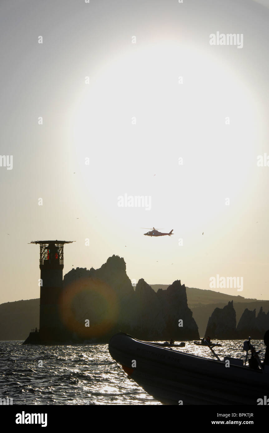 Rib and helicopter in silhouette by the needles lighthouse Stock Photo ...