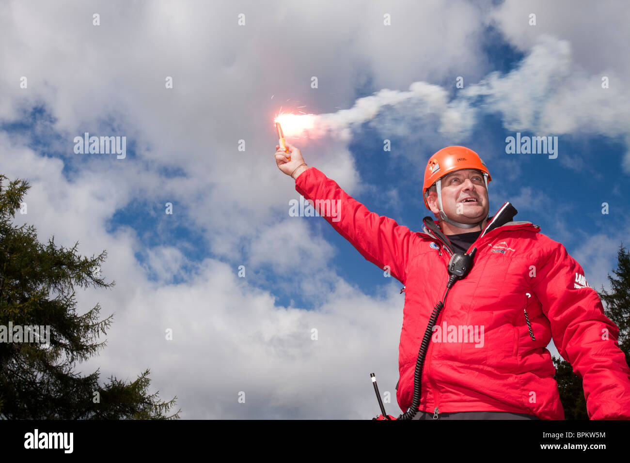 A member of Langdale/Ambleside Mountain Rescue Team uses a flare to ...