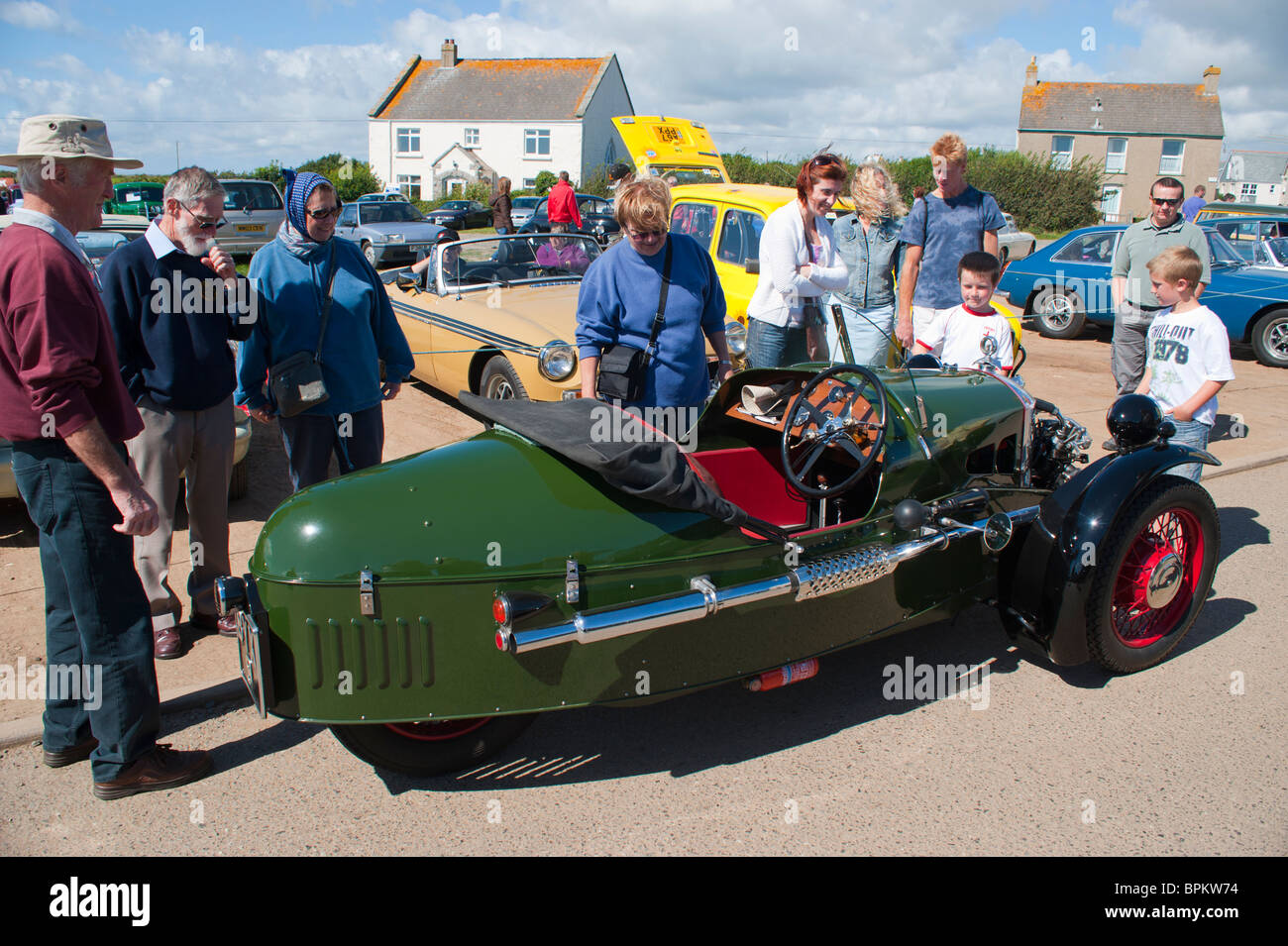 People enjoying a classic car show at the Lizard in Cornwall. Bank ...