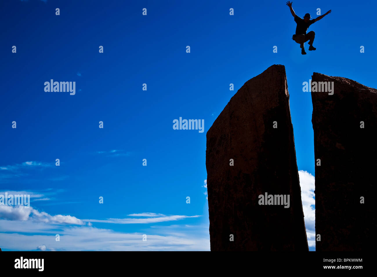 Climber celebrates on the summit of a rock spire in the Sierra Nevada ...