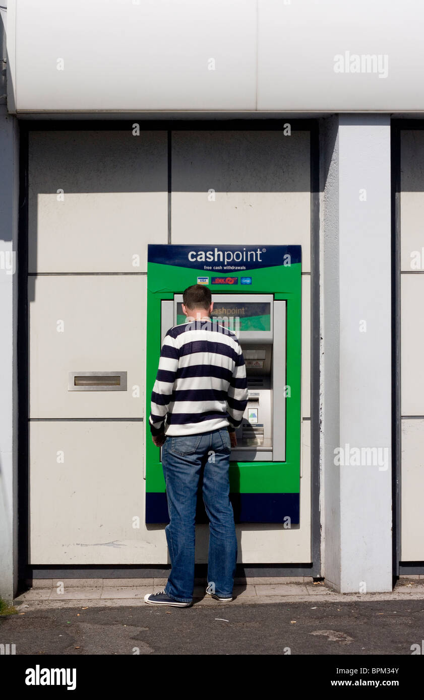 Man using ATM Cashpoint machine Stock Photo - Alamy