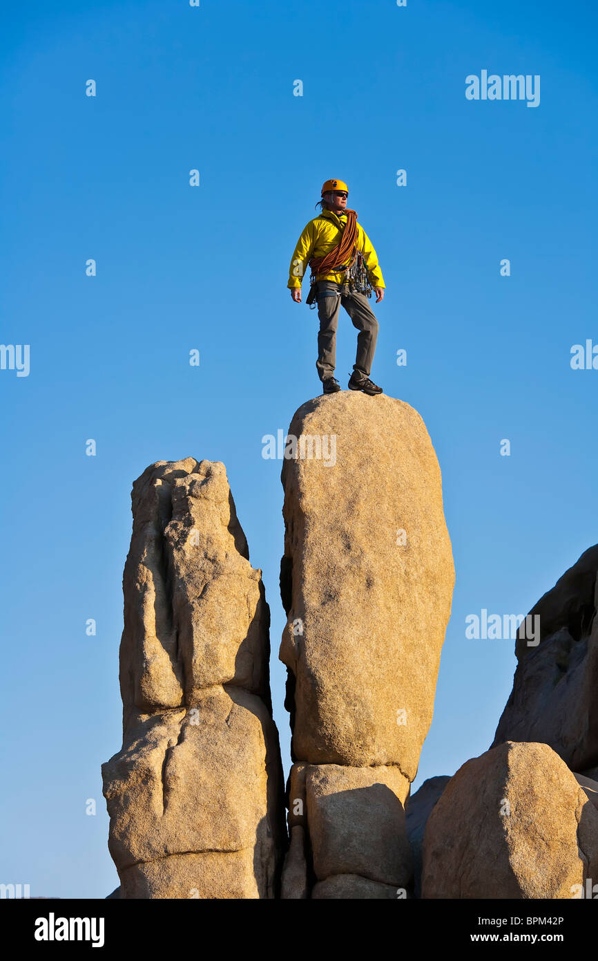 Climber celebrates on the summit of a rock spire in the Sierra Nevada ...