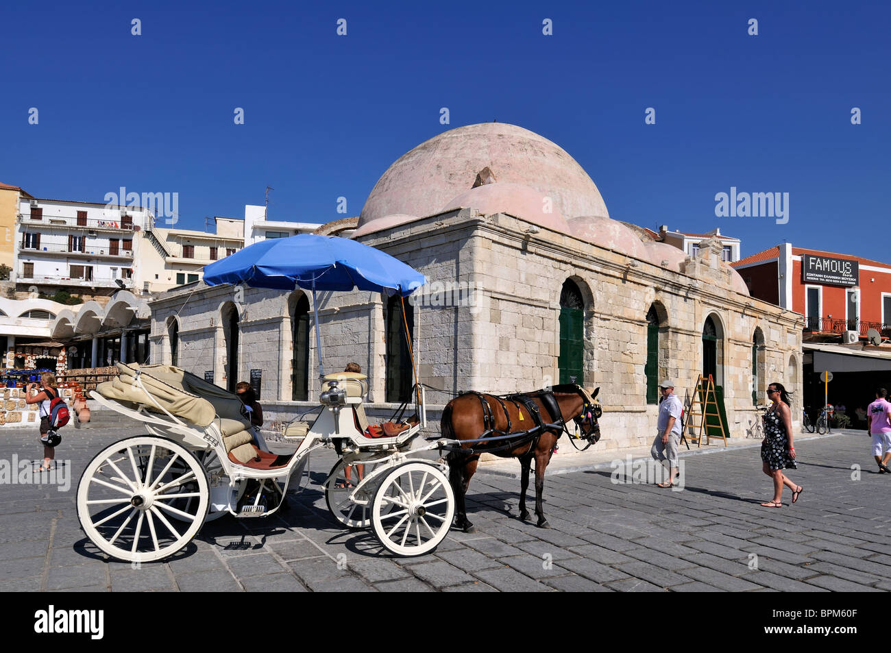 Horse carriage in front of the Turkish baths at the old port of Chania ...