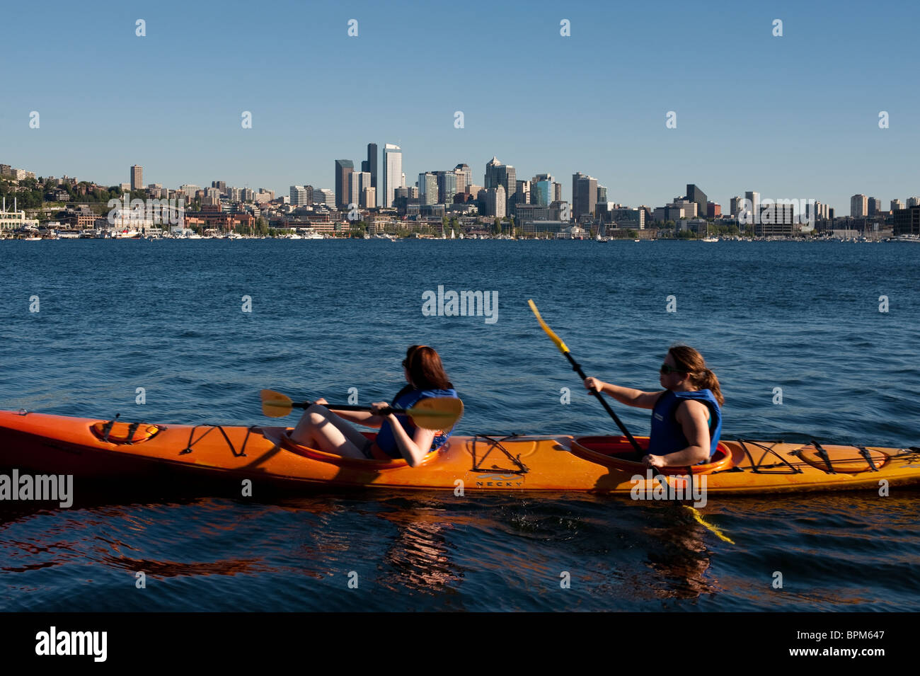 Retro image of Seattle Skyline with sailboats on Lake Union with people ...