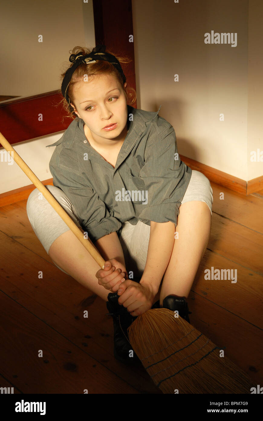 young housekeeper with a broom Stock Photo - Alamy