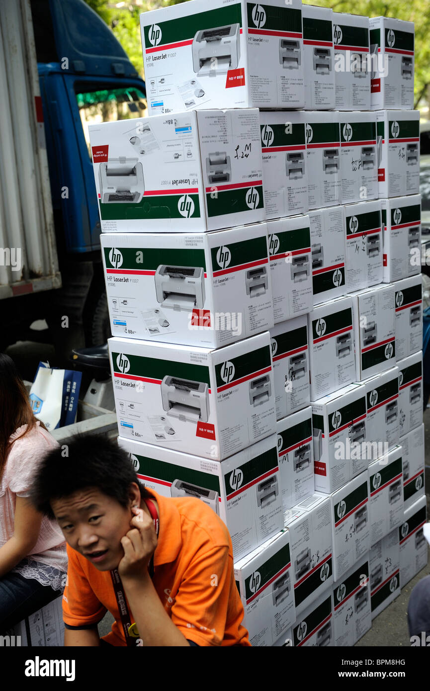 Chinese man sitting aside HP printers in Beijing, China.25-Aug-2010 ...