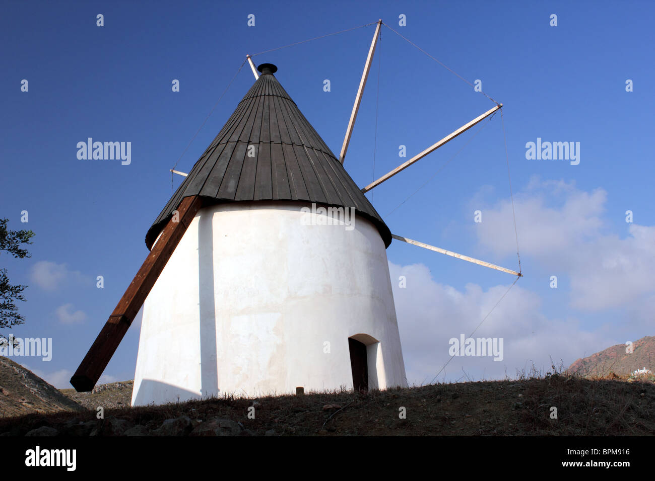 Typical white Spanish windmill against a deep blue sky; outside the ...