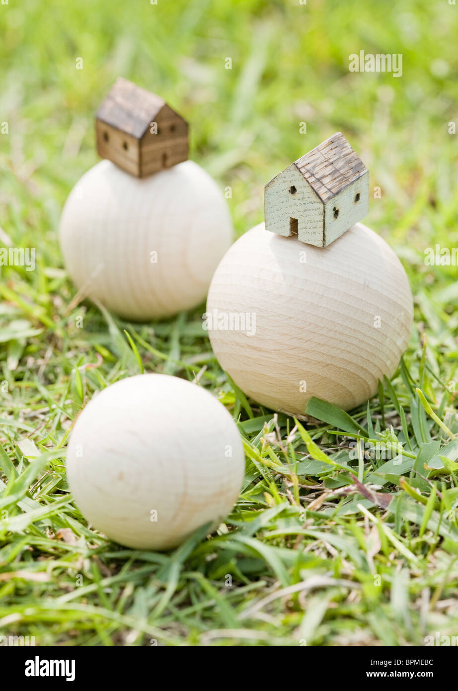 Wooden balls and miniature houses Stock Photo - Alamy