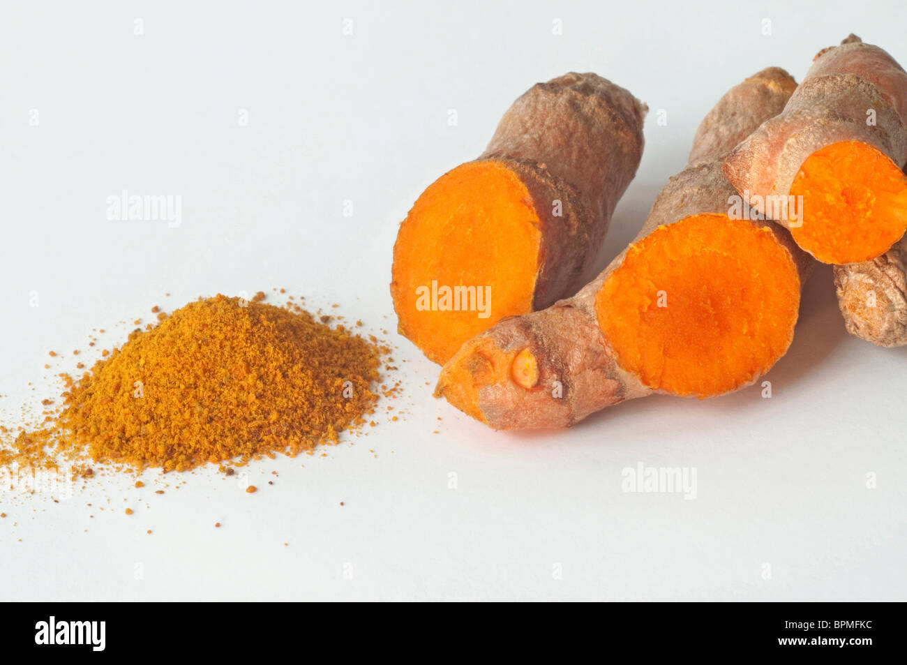Turmeric (Curcuma longa, Curcuma domestica), cut roots and powder ...
