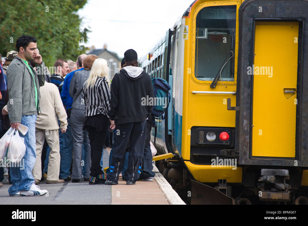 Passengers boarding train in station at Llandrindod Wells Powys Mid ...