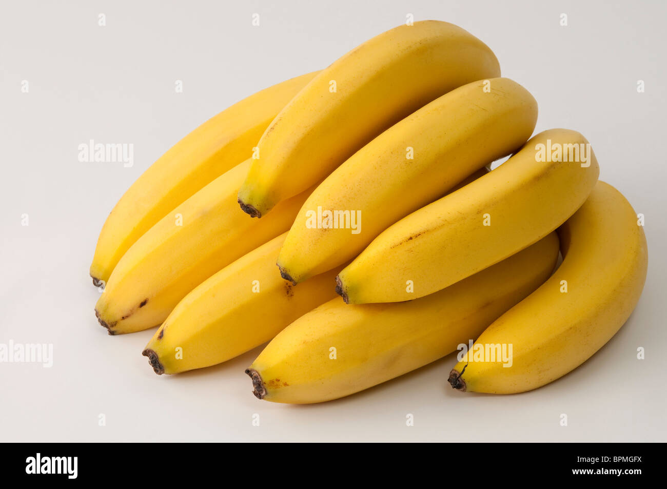 Banana (Musa x paradisiaca), ripe fruit. Studio picture against a white ...