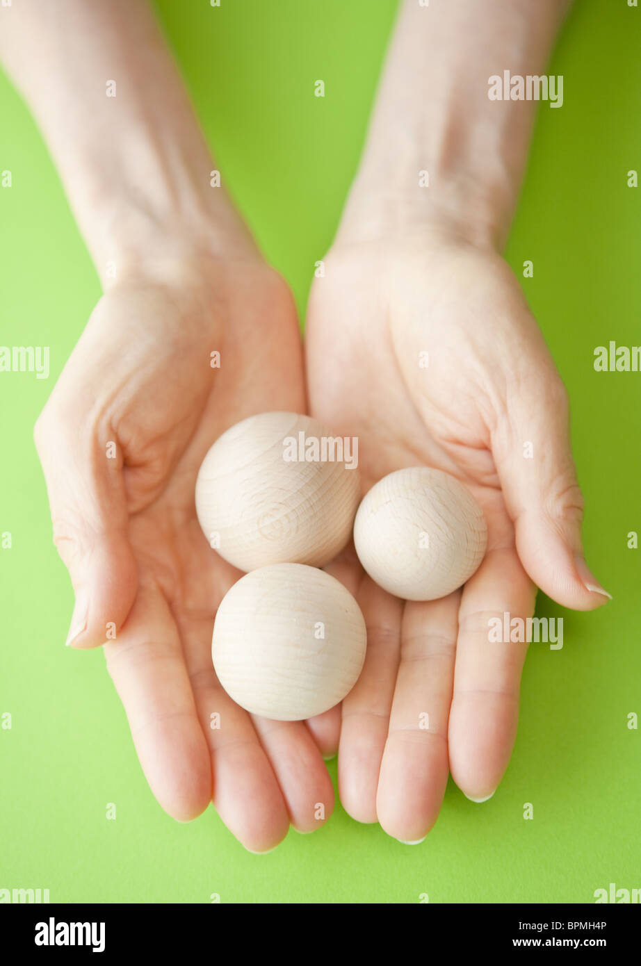 Hands holding small wooden balls hi-res stock photography and images ...