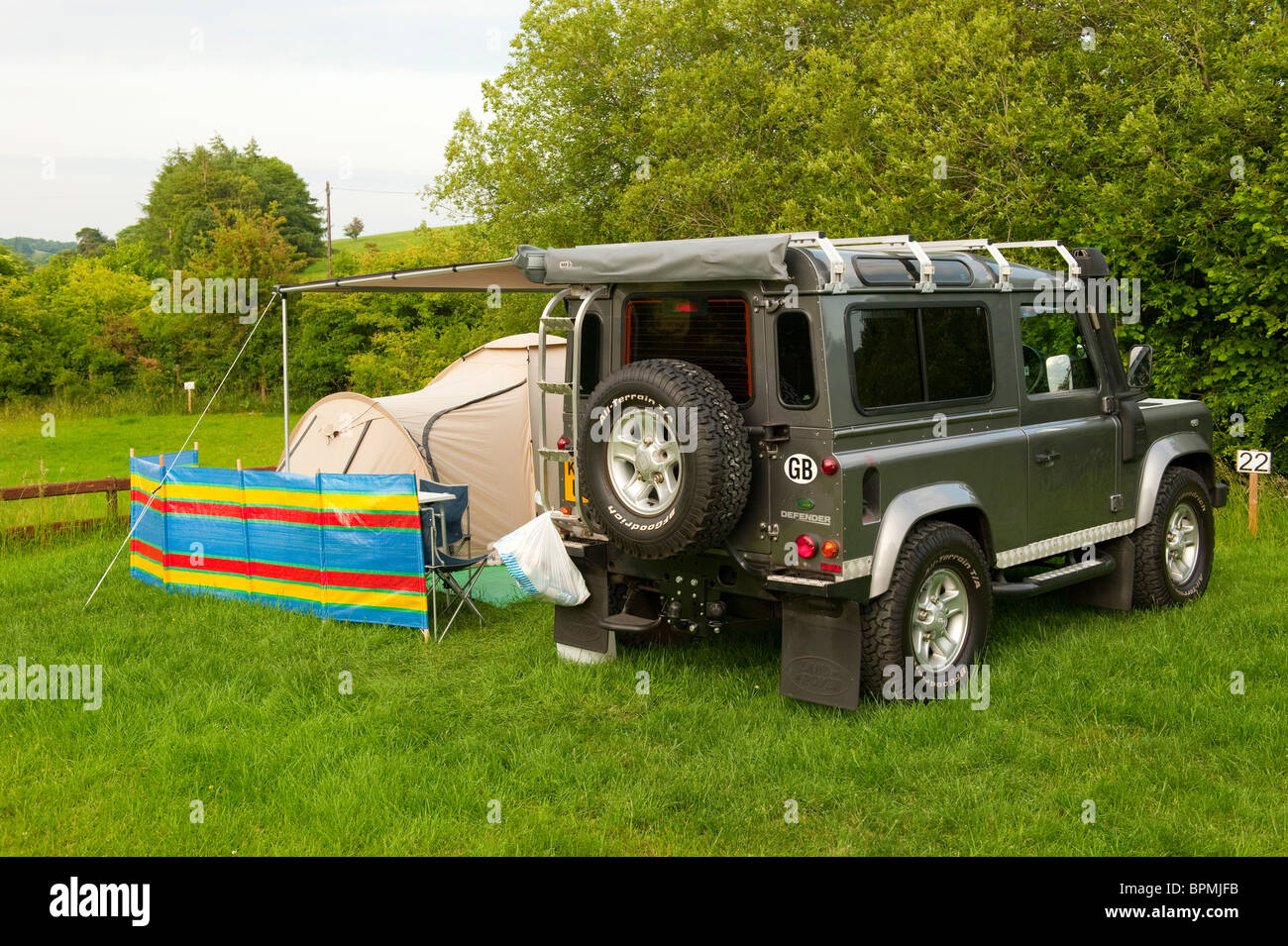 Landrover defender with awning and tent attached Stock Photo - Alamy